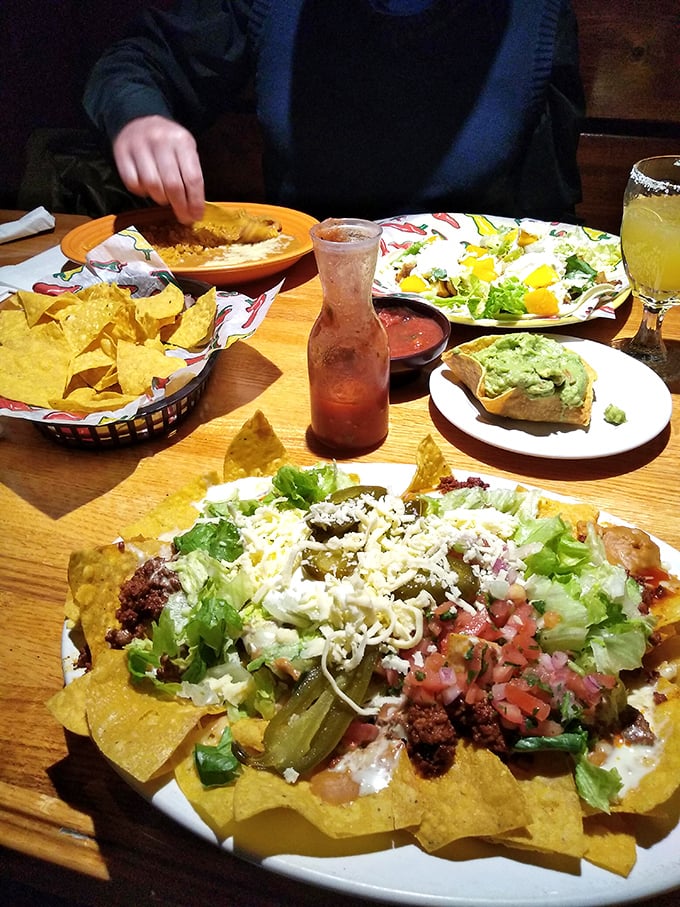 Nachos aren't just an appetizer here—they're an architectural achievement of chips, cheese, and toppings that would make Frank Gehry jealous.