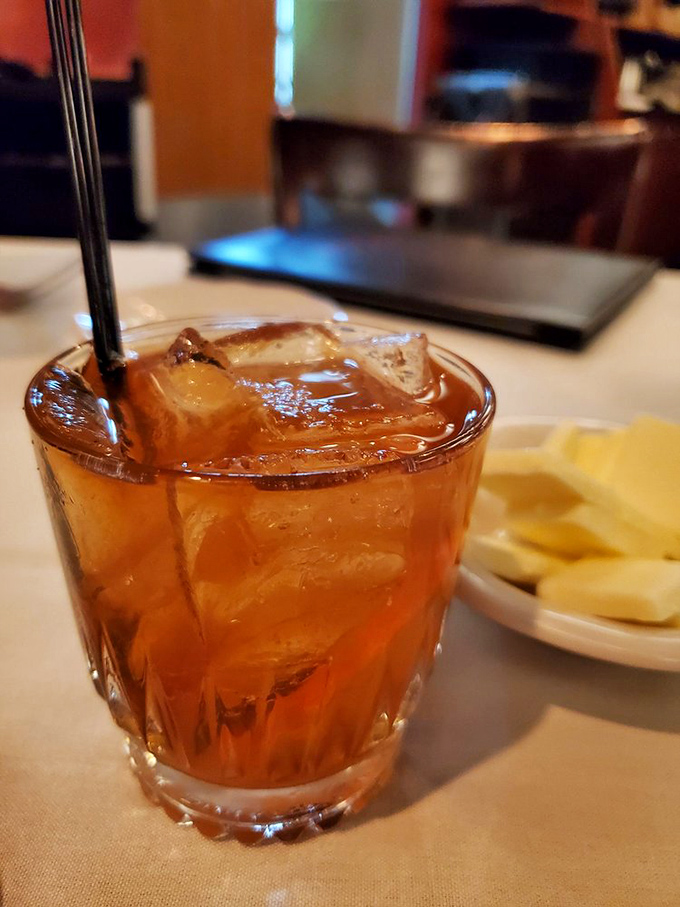 An Old Fashioned sitting pretty on white linen—because sometimes the perfect cocktail is the one that's stood the test of time.