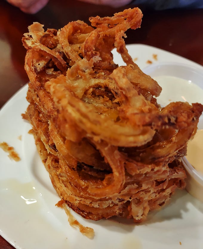 The onion loaf—where individual onion rings decided to form a delicious support group. Crispy, golden, and impossible to eat without smiling.