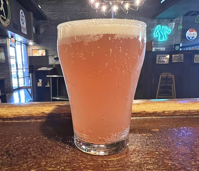Nothing complements pizza like a cold, frothy beverage – this amber delight waits patiently at the bar for its perfect pizza pairing.