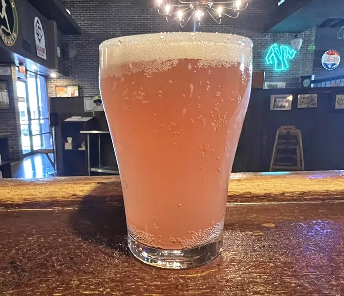 Nothing complements pizza like a cold, frothy beverage – this amber delight waits patiently at the bar for its perfect pizza pairing.