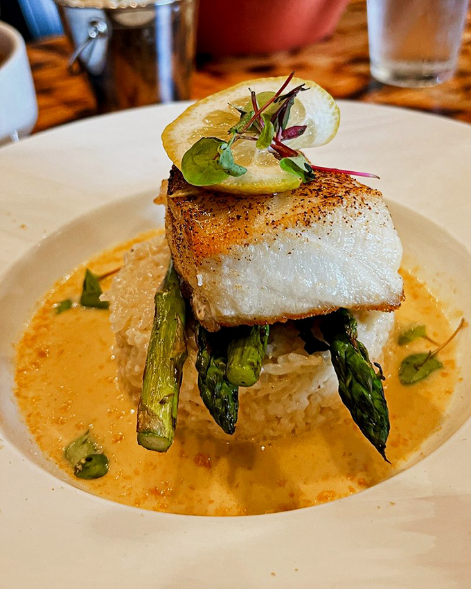 Sea bass perched majestically atop asparagus spears and rice, swimming in a sauce so good you'll want to request a straw on the side.