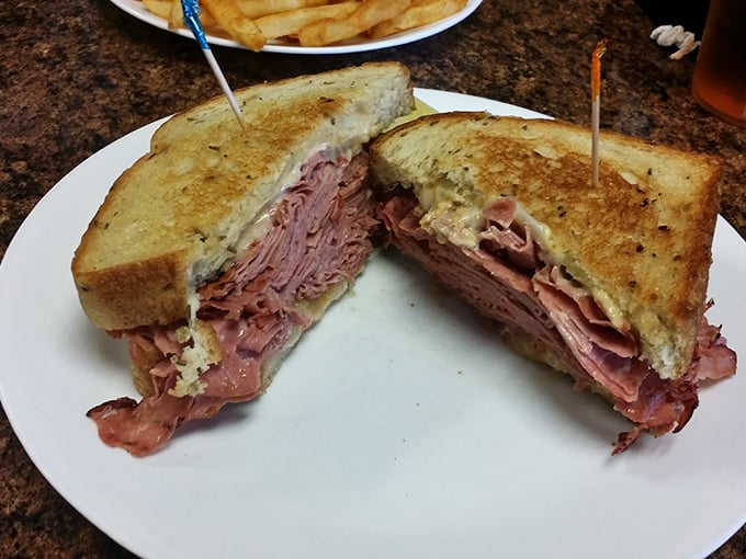 Not just any sandwich—a monument to pastrami perfection with meat stacked higher than some Florida buildings, grilled to toasty, melty magnificence.