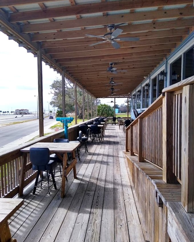 The patio doesn't just offer seating – it offers perspective. Ocean breezes and wooden planks create the perfect seafood dining soundtrack.