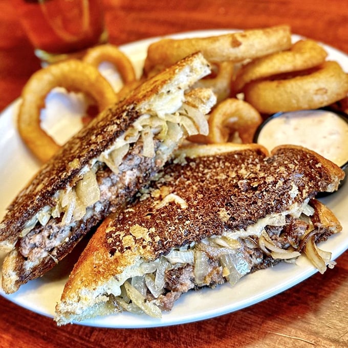 The patty melt—that glorious intersection where burger meets grilled cheese. Those perfectly grilled onions are the supporting actors who steal the show.