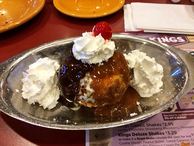 Dessert that defies gravity and restraint – a pecan ball crowned with whipped cream that makes you wonder why you ever considered skipping the sweet finale.