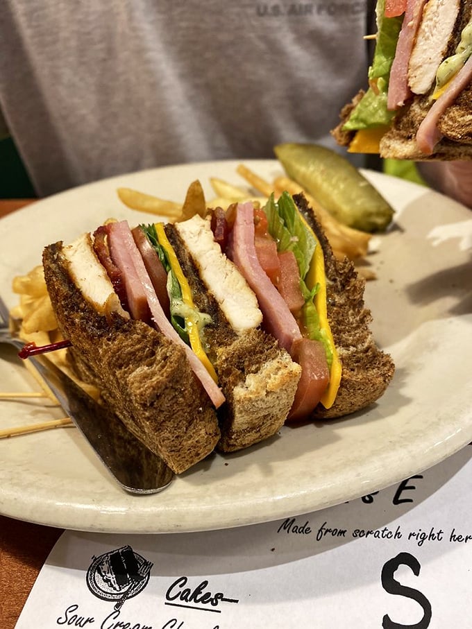 This club sandwich isn't just stacked—it's strategically engineered for maximum flavor in every bite. The toothpick is holding back greatness.