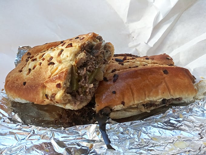 This hot sandwich, wrapped in foil like a precious gift, oozes with melted cheese and savory fillings. Worth every napkin you'll need.