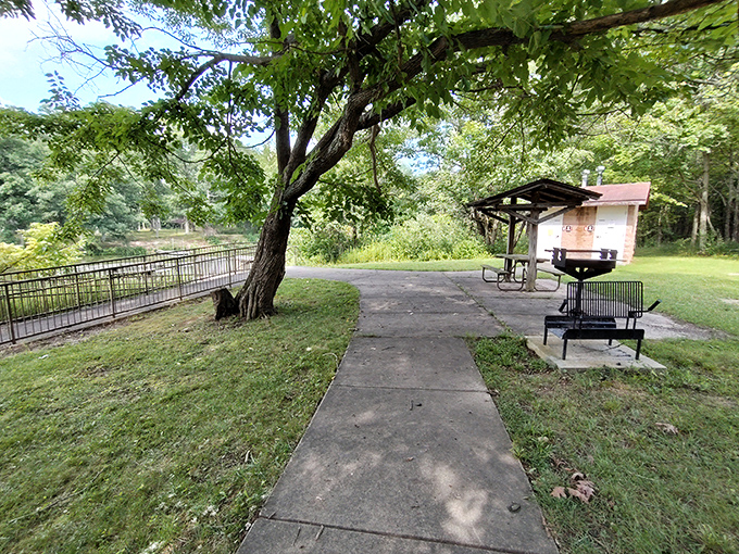 Social distancing, picnic-style. This concrete path leads to grills that have witnessed more family debates than Thanksgiving dinner tables.