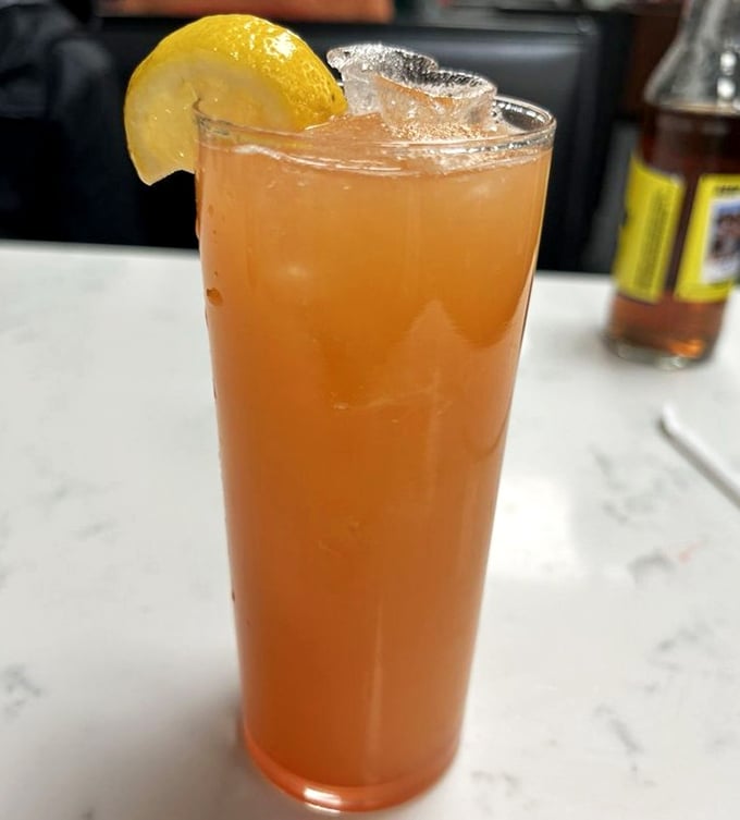 Liquid sunshine in a glass. This refreshing pineapple crush provides the perfect sweet counterpoint to the savory sandwich experience.