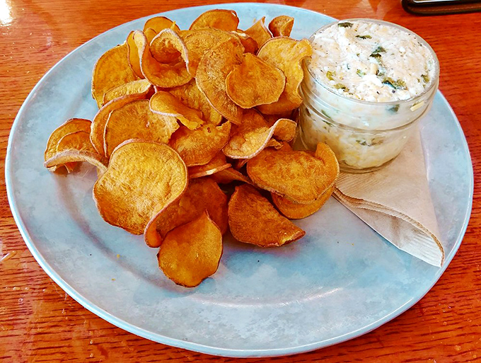 Sweet potato chips—crisp as autumn leaves—stand ready to ferry that creamy poblano pimento cheese from plate to palate in perfect harmony.