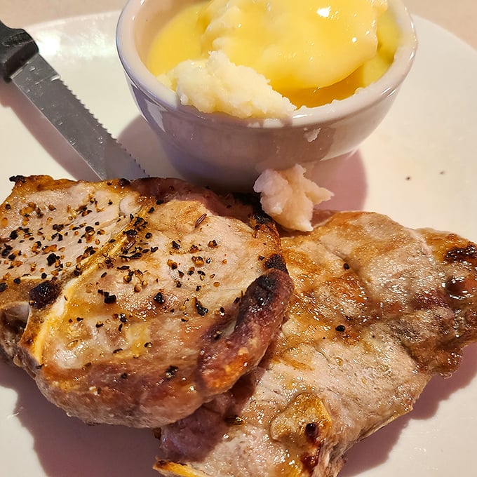 Pork chops that have clearly been introduced to fire with proper respect. That side of applesauce isn't just tradition—it's the law.