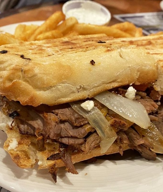 When a sandwich requires structural engineering—tender pot roast, caramelized onions, and melty cheese creating the comfort food equivalent of a warm hug.