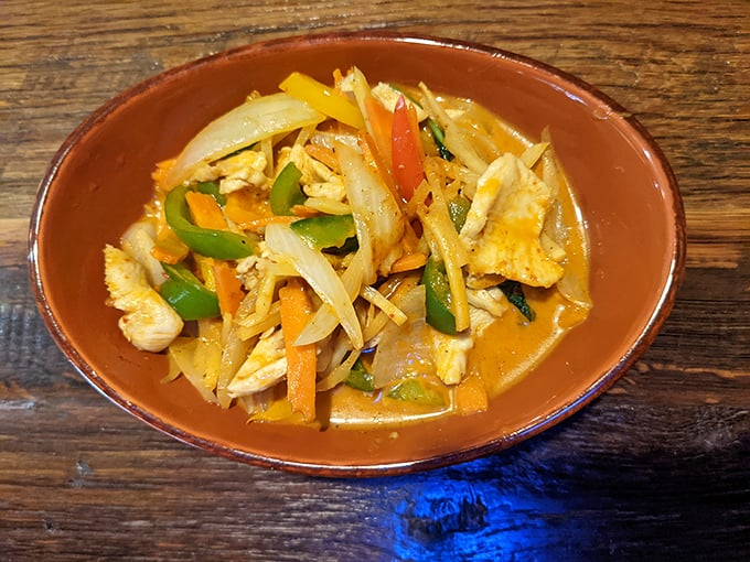 This isn't just curry—it's a sunset in a bowl, with vegetables and chicken swimming in a sauce worth bottling and taking home.