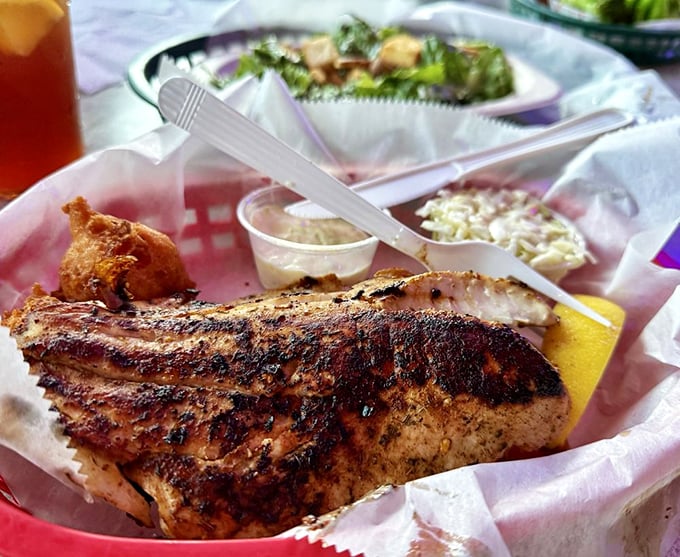 Blackened to perfection, this fish filet wears its seasoning like a badge of honor. The coleslaw side isn't just an afterthought—it's a cooling counterpoint.