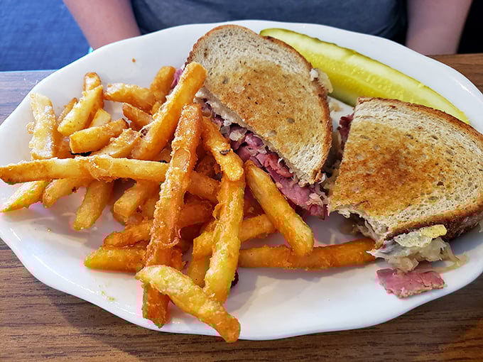 The Reuben at Beacon 443 isn't just a sandwich—it's architecture. Perfectly grilled rye supporting a skyscraper of corned beef, with those golden fries standing guard like delicious sentinels.