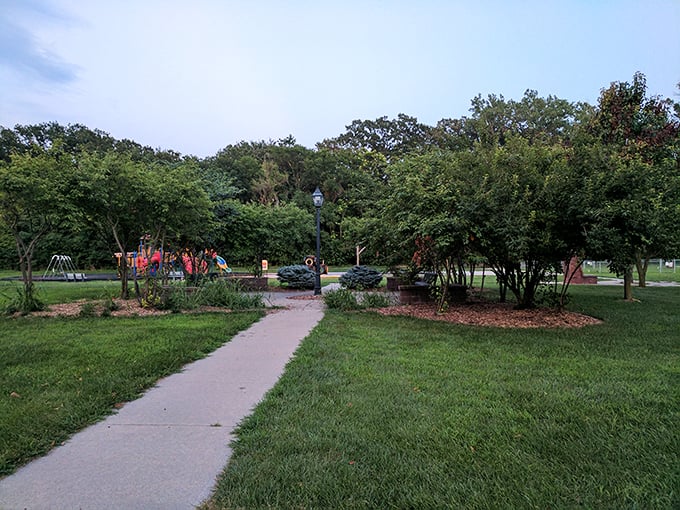 Rhylander Park offers a green respite where generations of Plattsmouth families have created memories beneath the watchful gaze of towering trees.