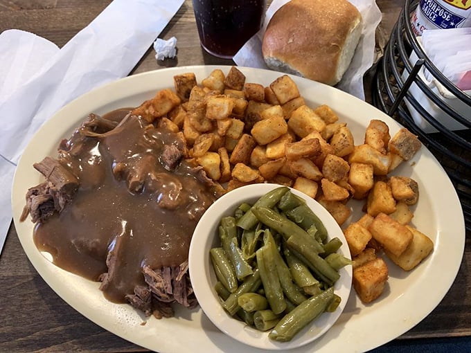 Pot roast that surrenders at the mere suggestion of a fork, crowned with gravy and accompanied by home fries that put fast food potatoes to shame.