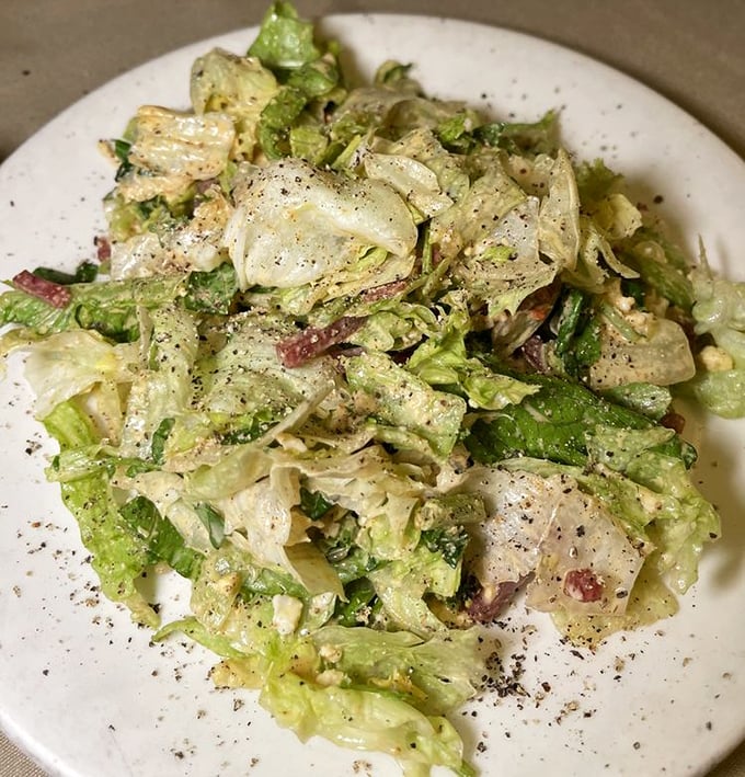 Even the salad gets the royal treatment. Fresh, crisp greens tossed tableside with a dressing that makes vegetables temporarily more interesting than meat.