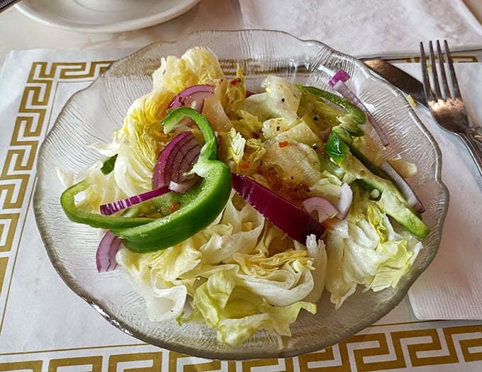 Even the house salad gets the respect it deserves—crisp lettuce, vibrant peppers, and red onions dressed simply to let the ingredients shine.