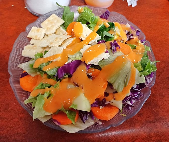 A salad that proves vegetables can party too—vibrant, colorful, and dressed to impress with crackers standing by for moral support.