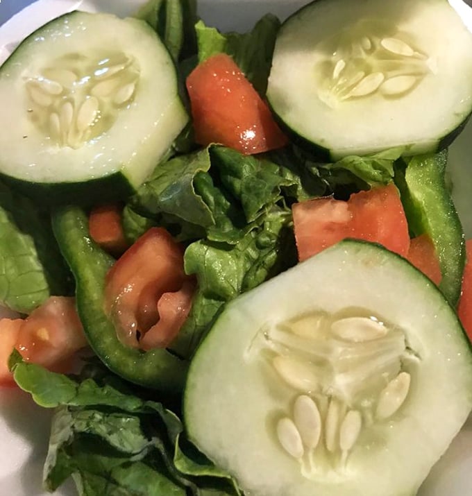 A garden party in a bowl – crisp cucumbers, juicy tomatoes, and fresh greens that actually make you excited about eating vegetables.