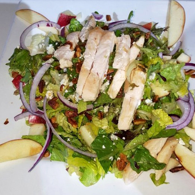Even salads get the royal treatment here—fresh greens, grilled chicken, and crisp apples proving healthy eating doesn't have to be punishment.