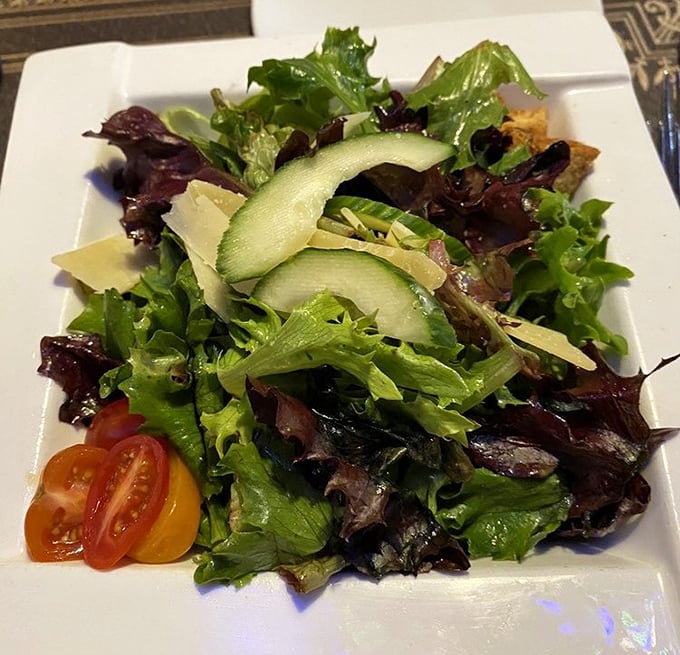 A salad that actually deserves respect—crisp greens, cucumber ribbons, and tomatoes that didn't grow up in some sad refrigerated truck.
