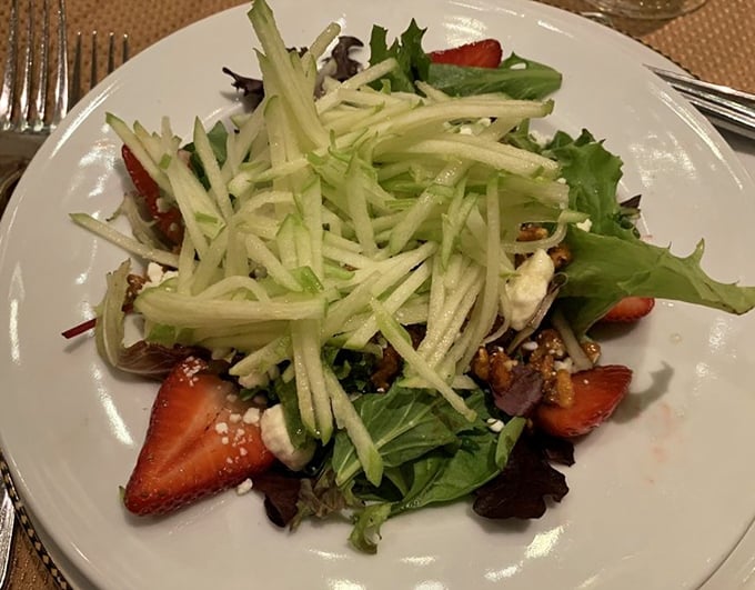 A salad that proves green things can be exciting—where strawberries and crisp apple strands transform ordinary lettuce into something worth talking about.