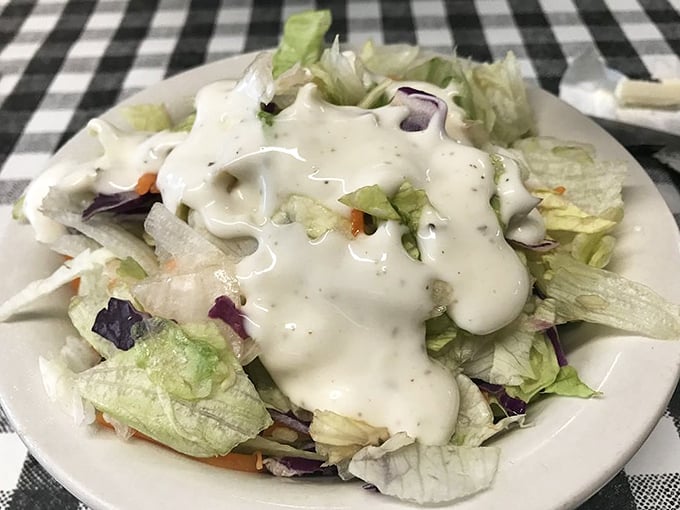 A simple garden salad with house dressing—because sometimes you need something green before diving into that banana pudding.