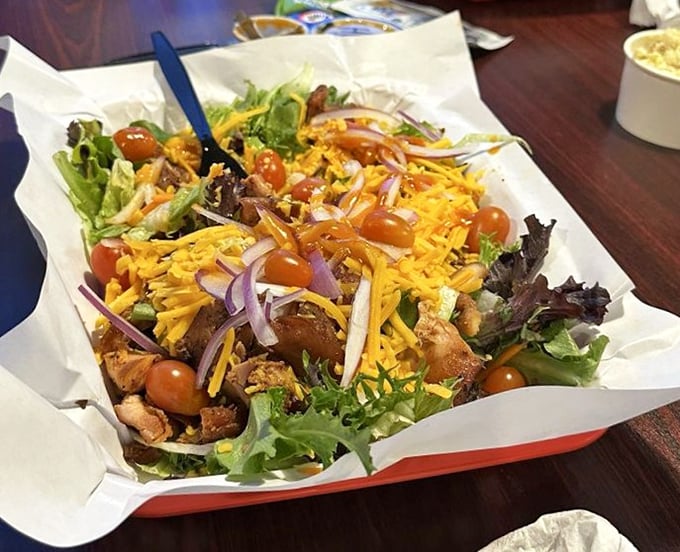 Even salad gets the BBQ treatment here, proving that vegetables can hang with the cool kids when properly introduced to smoked meat.