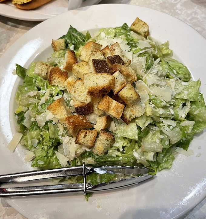Even the Caesar salad gets the respect it deserves – crisp romaine, house-made croutons, and enough garlic to keep vampires out of Greenwich Village.