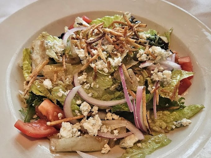 A salad that actually excites—crisp greens, ripe tomatoes, and crumbled cheese create a symphony of textures that makes eating vegetables feel like cheating.