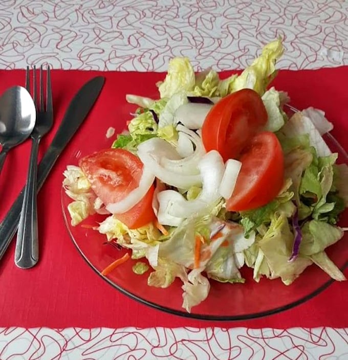 A fresh garden salad that actually looks like it came from a garden—crisp, colorful, and the perfect counterbalance to diner indulgences.