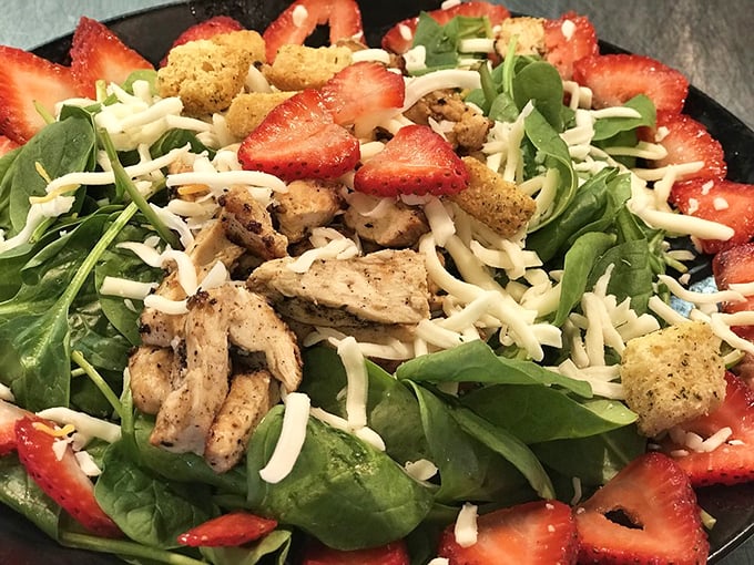 Even their salads mean business—fresh strawberries and grilled chicken prove healthy eating doesn't have to be punishment.