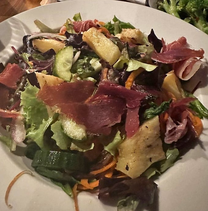 The house salad brings unexpected delight – fresh, colorful, and substantial enough to make you forget you came for the wings. Almost.