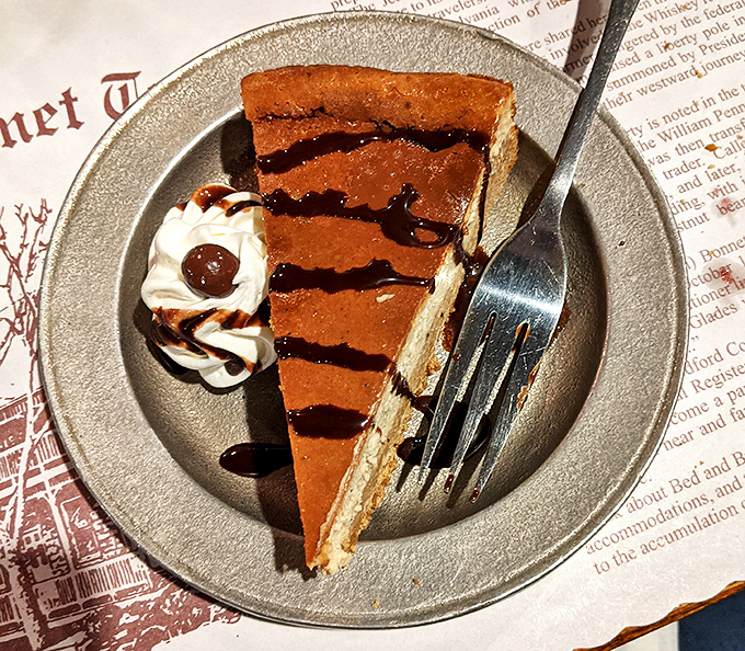 Chocolate cheesecake drizzled with caramel stripes like it's dressed for a very delicious formal occasion. Save room or live with regret!