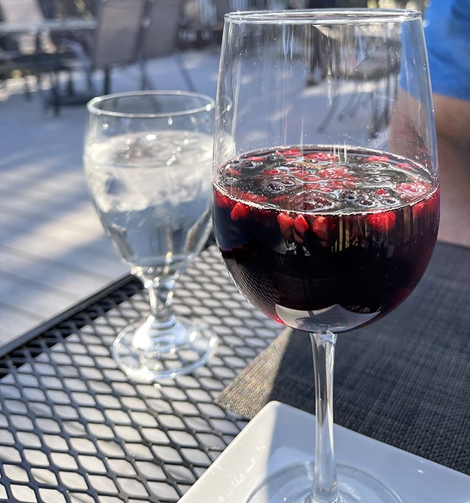 Wine on the outdoor patio – where sangria's deep ruby glow promises relaxation as reliable as Florida's afternoon sunshine.