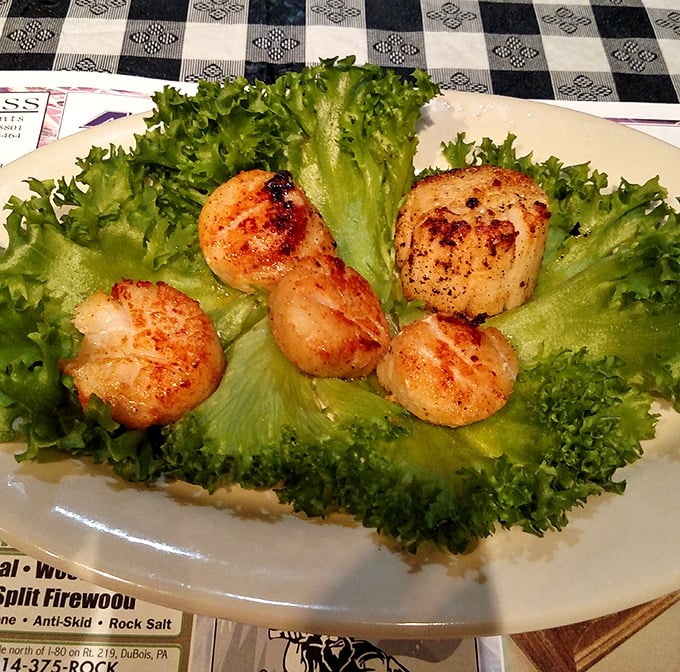 These seared scallops aren't just seafood—they're little buttery medallions of ocean perfection nestled on a bed of fresh greens.