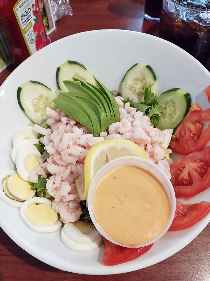 A salad that doesn't apologize for being healthy. Those bay shrimp and avocado slices are doing a delicious dance on a bed of greens.