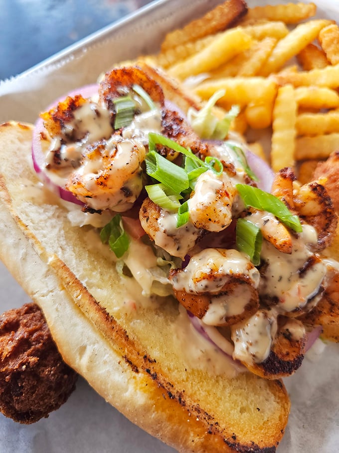 This isn't just a sandwich; it's architecture. Blackened shrimp nestled in a perfectly toasted roll with just the right amount of sauce and crunch.