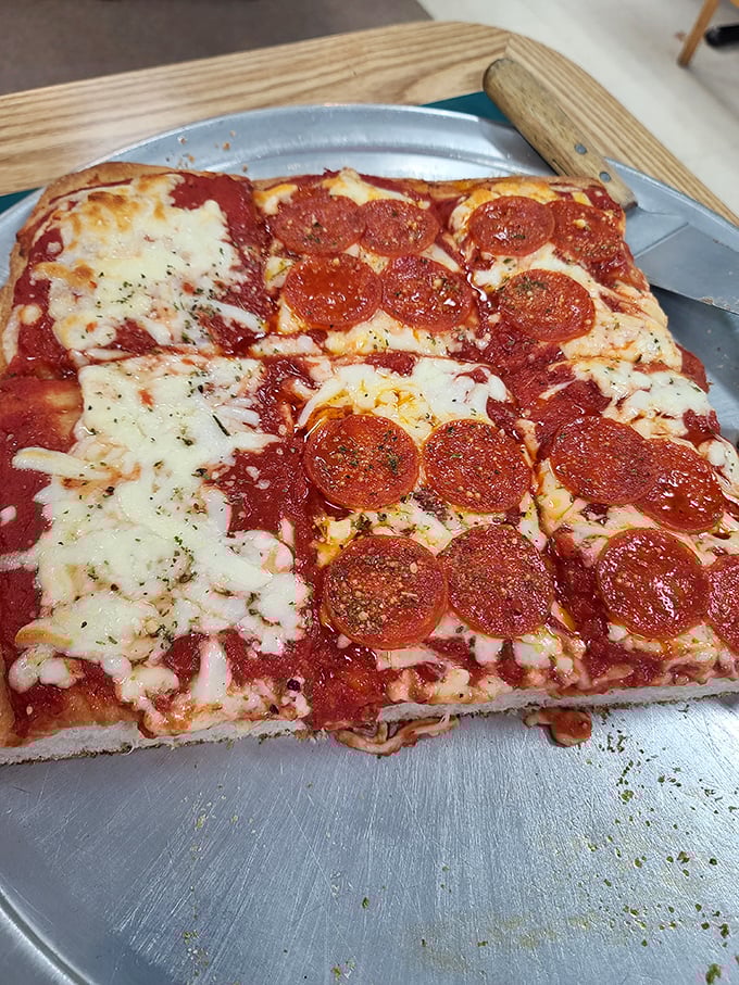 Sicilian pizza that demands respect—thick, substantial, and unapologetically bold. The kind of slice that makes you cancel your afternoon plans for a necessary nap.