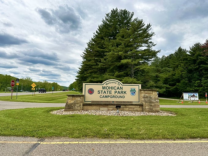 The entrance sign promises adventure while the towering pines stand guard. Like nature's own doorman welcoming you to the wilderness party.