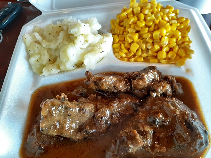 These smothered pork chops aren't just swimming in gravy—they're doing the backstroke in flavor. The mashed potatoes and corn make perfect sidekicks.