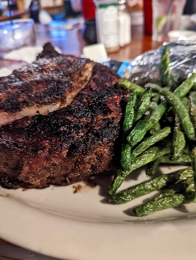 A perfectly seared steak alongside bright green beans – simple food done right is the ultimate form of culinary respect.