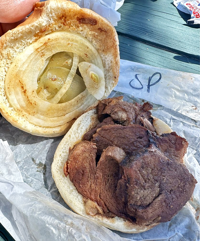 A sandwich that's more meat than bread – exactly as it should be. Those onions aren't garnish; they're the supporting actors in this meaty drama.