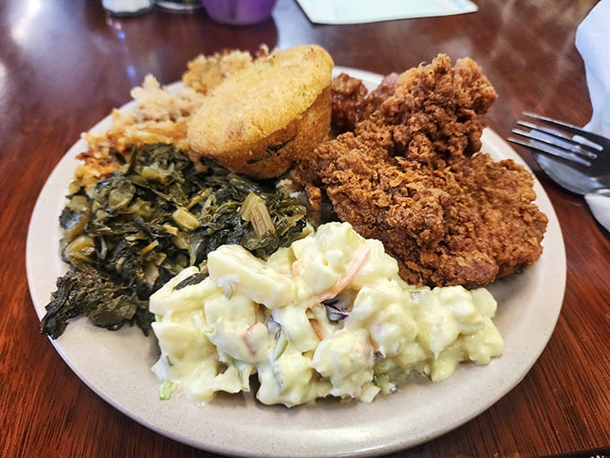 A plate that tells Mississippi's culinary story – crispy fried chicken, collard greens, and mac and cheese that tastes like someone's grandmother is in the kitchen.