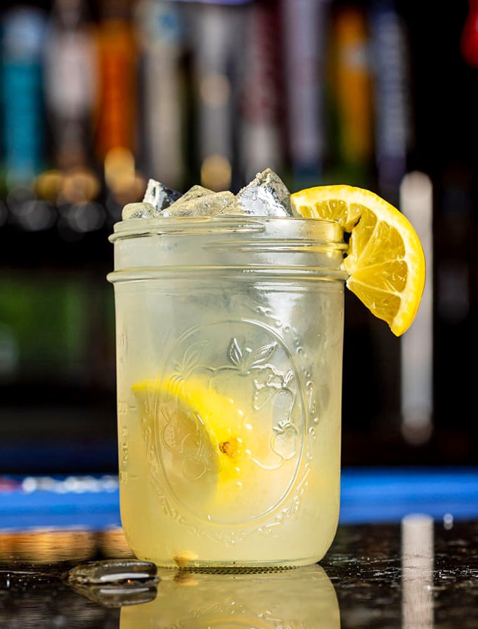 Mason jar lemonade with that perfect sweet-tart balance – summer in a glass, complete with a slice of sunshine on the rim.