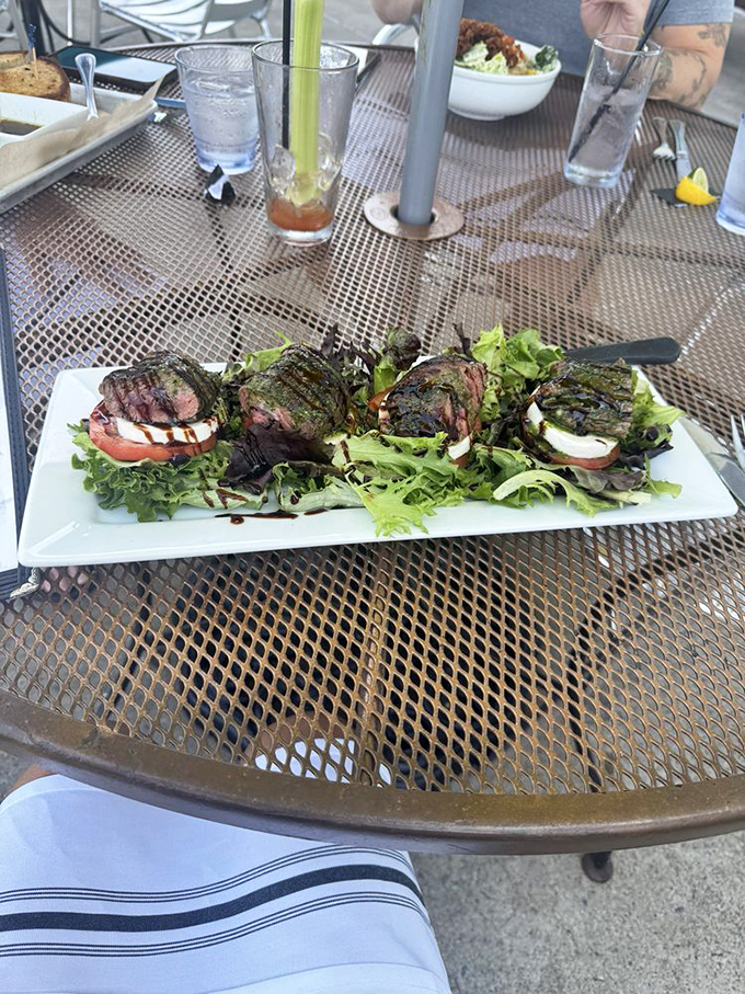 Steak Caprese that bridges the gap between steakhouse and trattoria. Those grill marks aren't just for show—they're flavor tattoos.