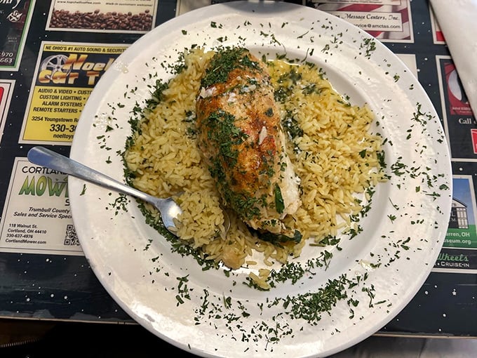 Stuffed baked cod nestled on a bed of rice – seafood comfort that would make coastal restaurants jealous of this Ohio gem.